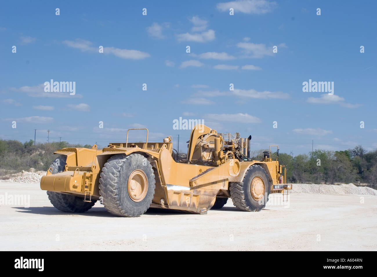 Large yellow heavy equipment earth mover scraper Stock Photo - Alamy