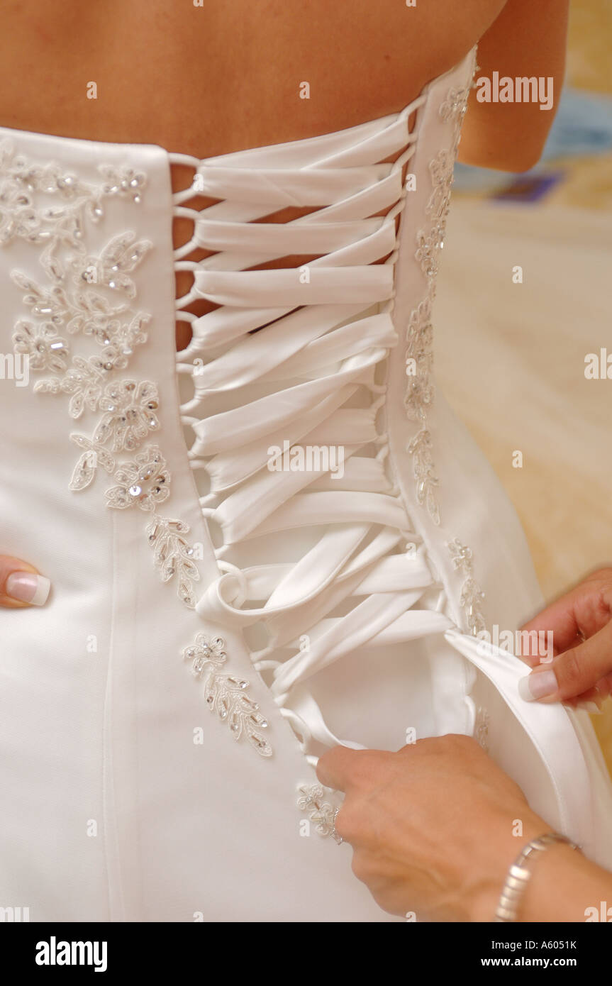 Bride being dressed Stock Photo - Alamy