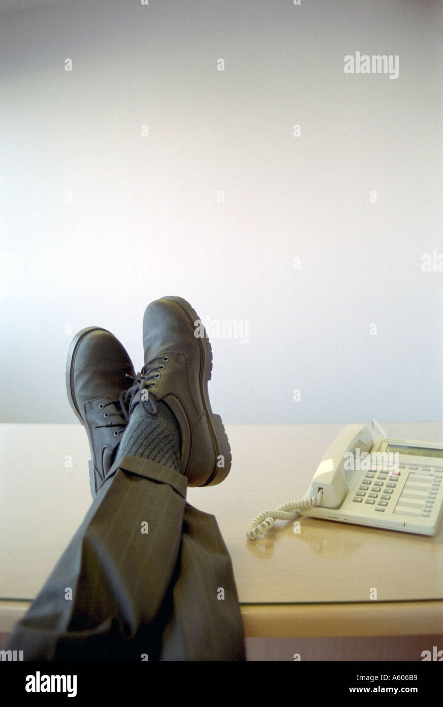 Businessman with feet on desk Stock Photo - Alamy