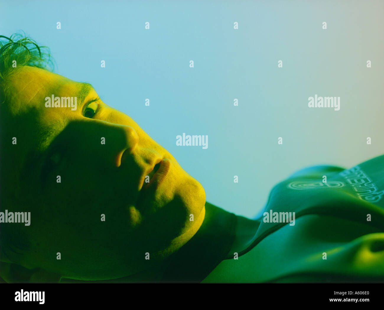 Man reclining in wetsuit Stock Photo - Alamy