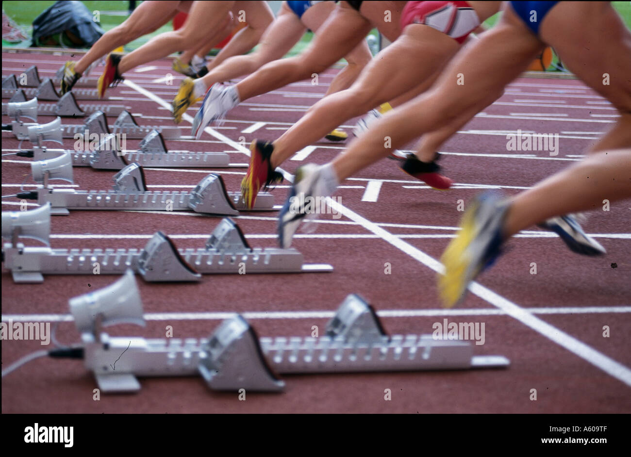 Low section view of runners leaving starting blocks on track Stock ...