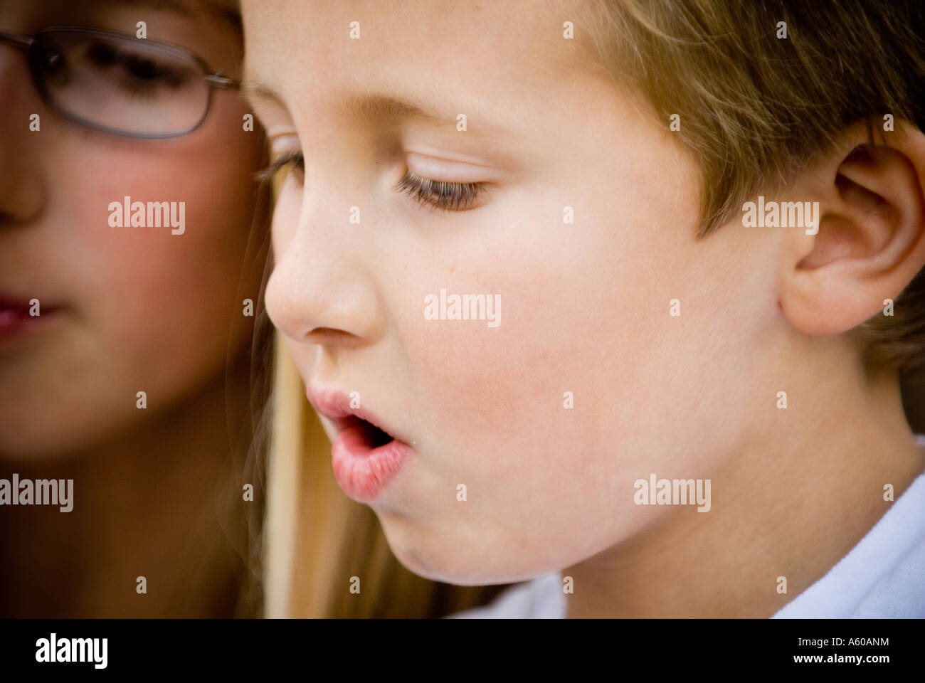 A happy brother and sister listen to a music player together Stock ...