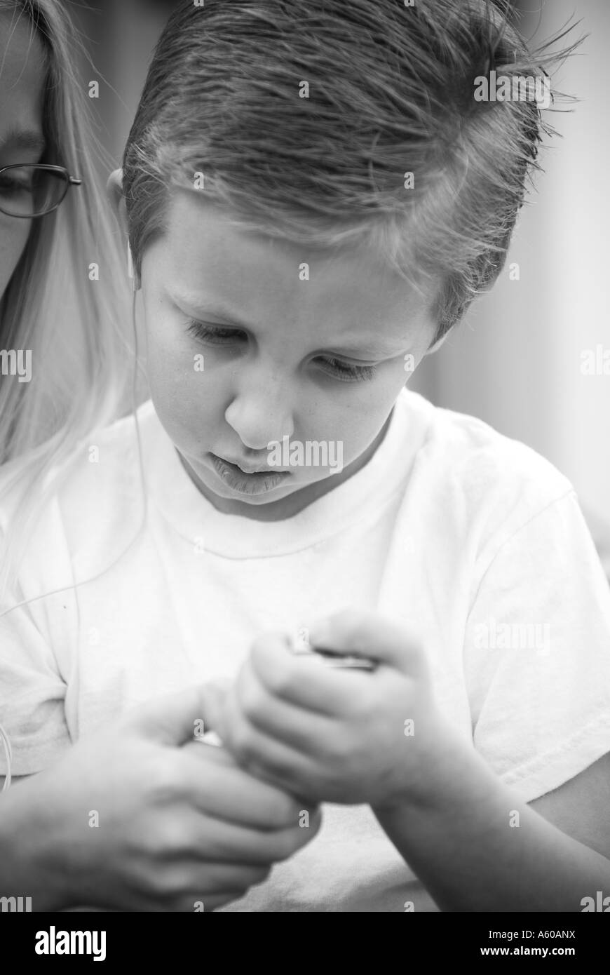 A happy brother and sister listen to a music player together Stock ...