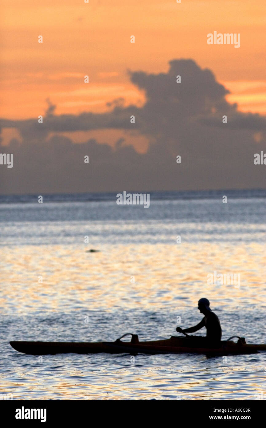 Outrigger canoeing at sunset off the island of Tahiti Stock Photo - Alamy