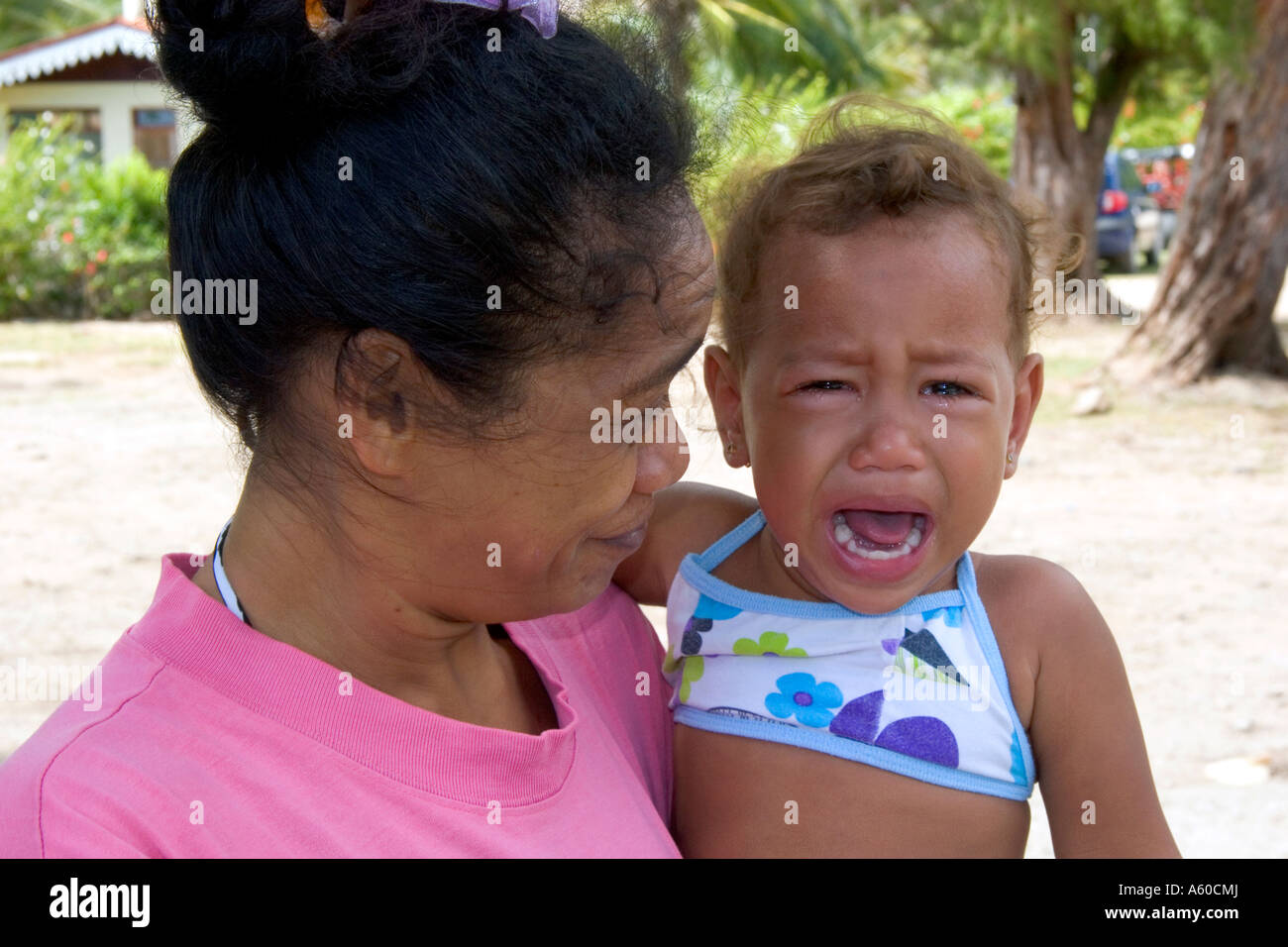 Tahitian woman with a crying child on the island of Moorea Stock Photo ...