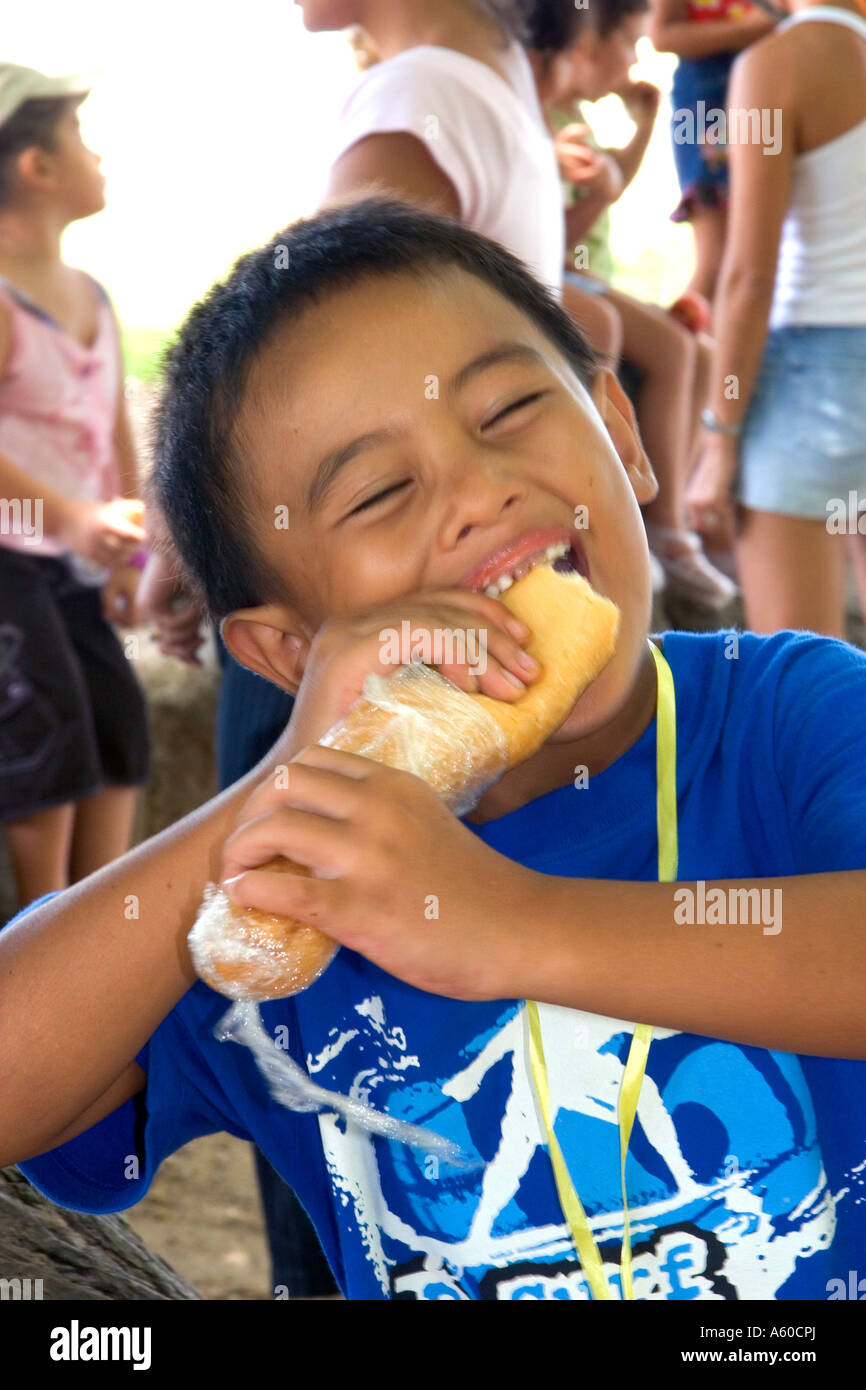 Tahitian boy eating a sandwich on the island of Moorea Stock Photo - Alamy