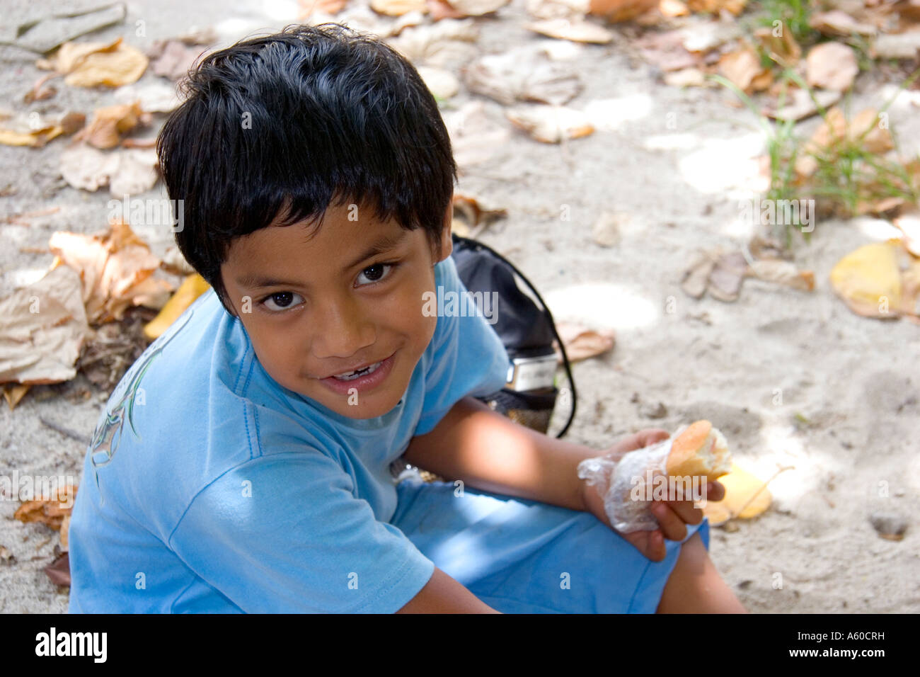 Young Tahitian boy having lunch on the island of Moorea Stock Photo - Alamy