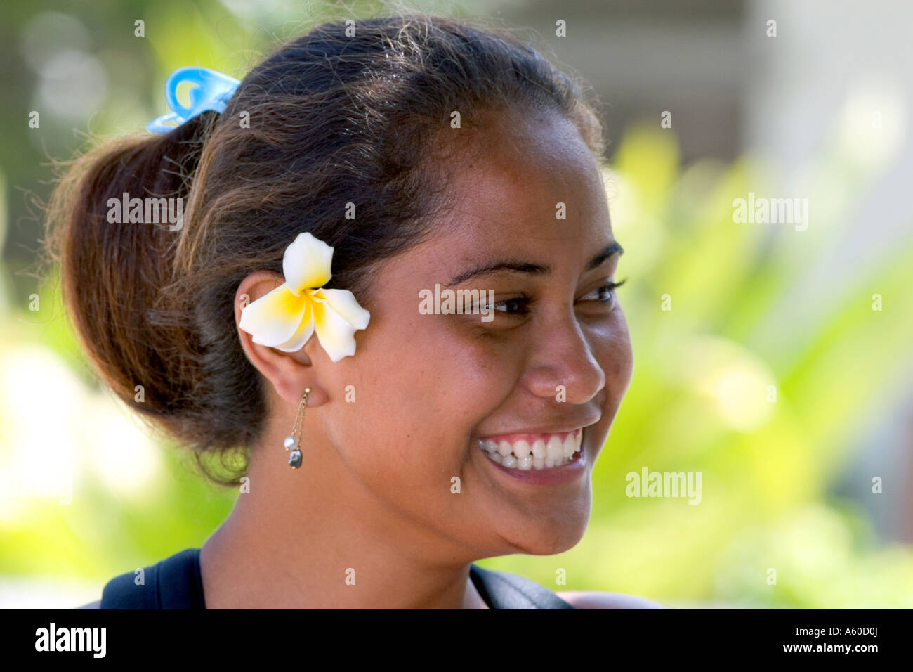 Tahitian woman wearing a plumeria flower in her hair on the island of ...