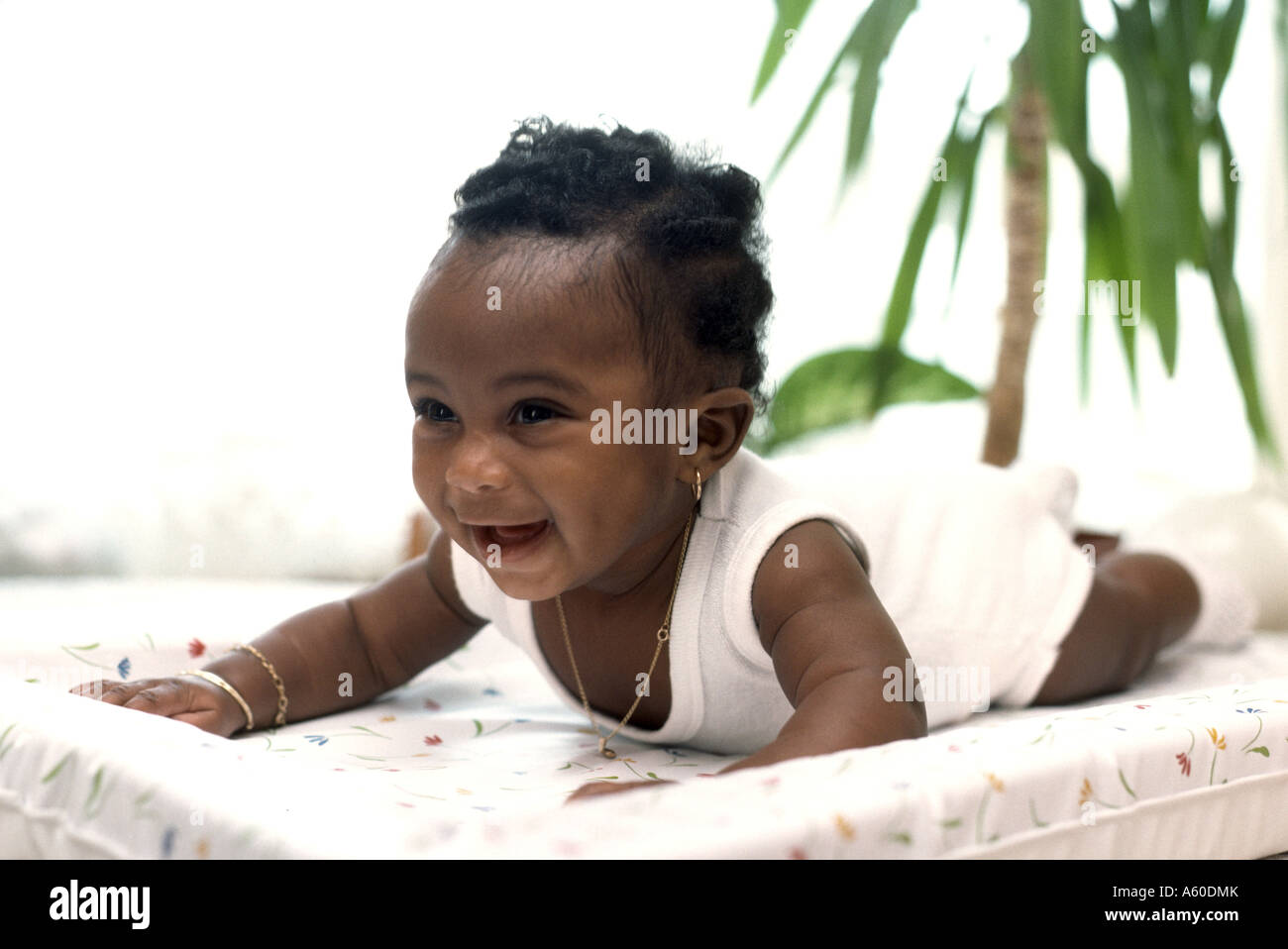 Six month old baby begins to raise his head while lying on her stomach ...