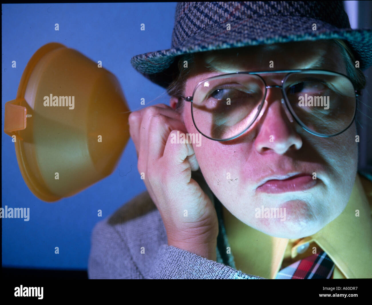 Man with hat and glasses holding funnel Stock Photo - Alamy