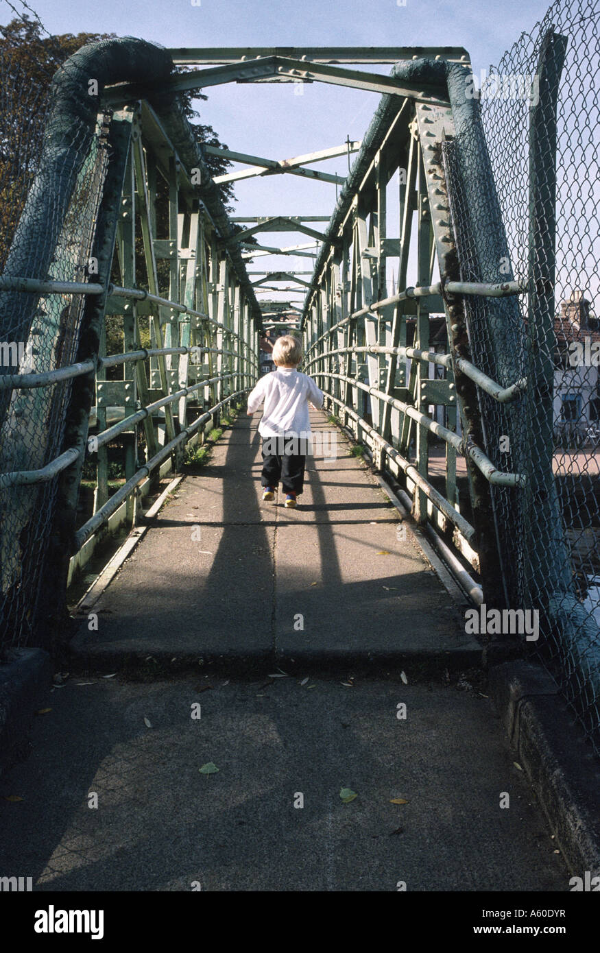 young boy crossing a pedestrian bridge all alone Stock Photo - Alamy