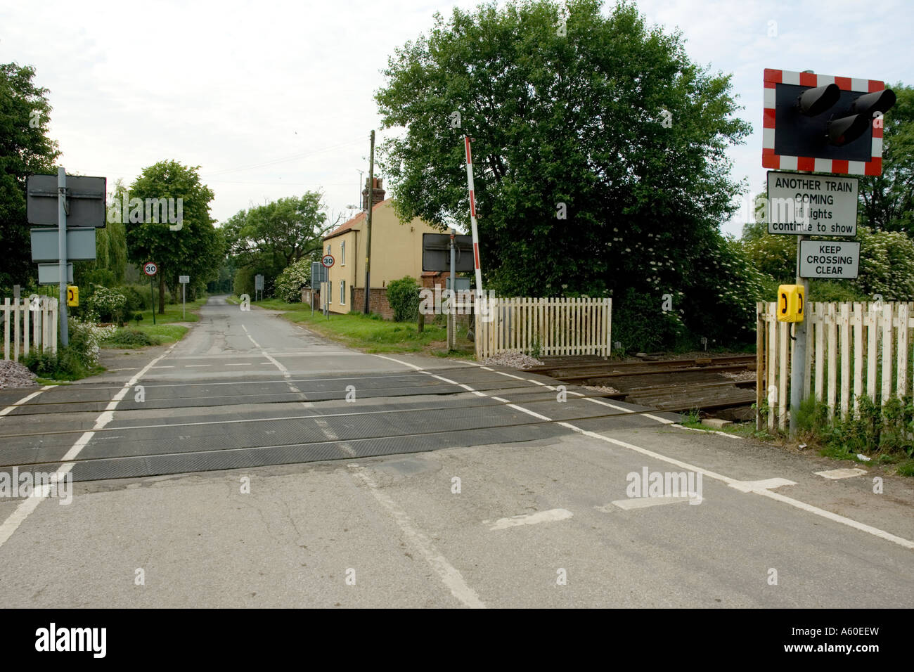 Local village railway crossing Stock Photo - Alamy