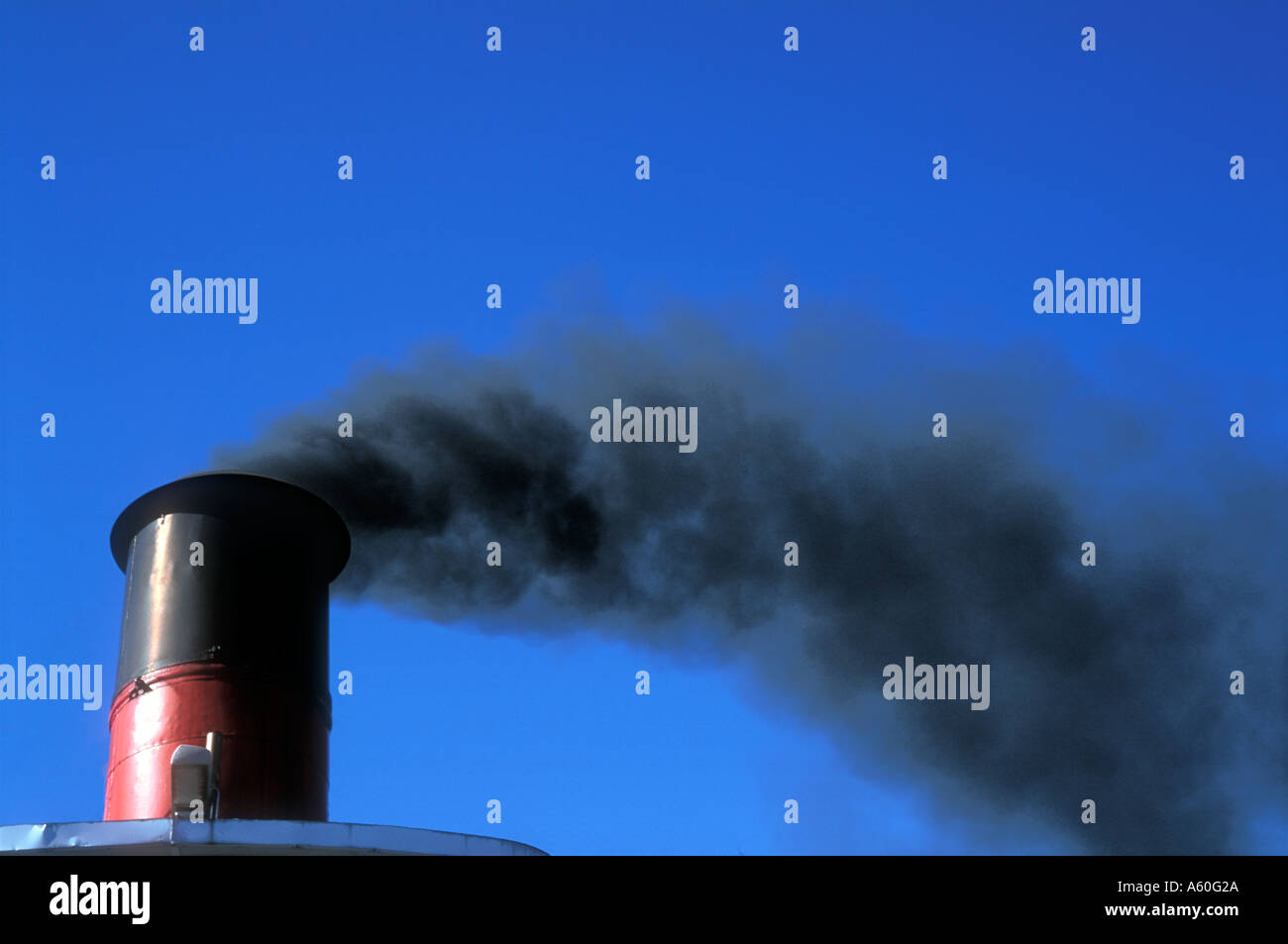 Smoke spewing out of the funnel of an old steamboat Stock Photo - Alamy