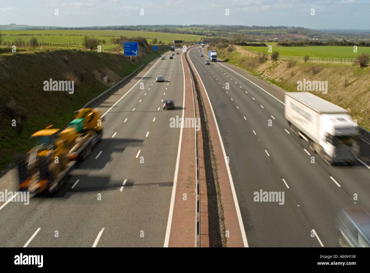Horizontal wide angle aerial view of traffic speeding along the M4 ...