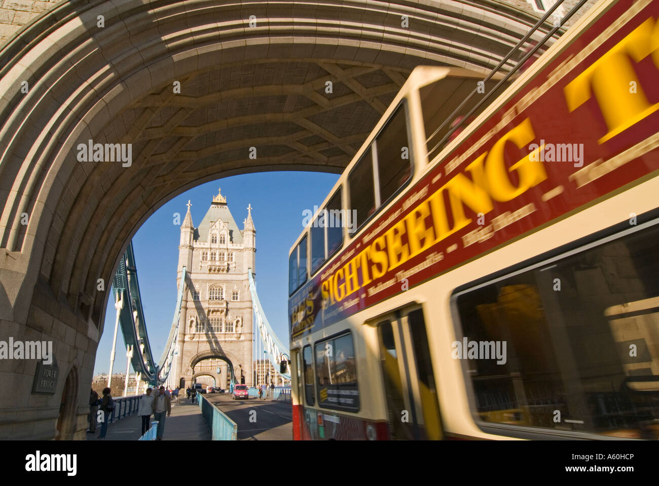 Horizontal wide angle of an open topped tourist bus crossing Tower ...
