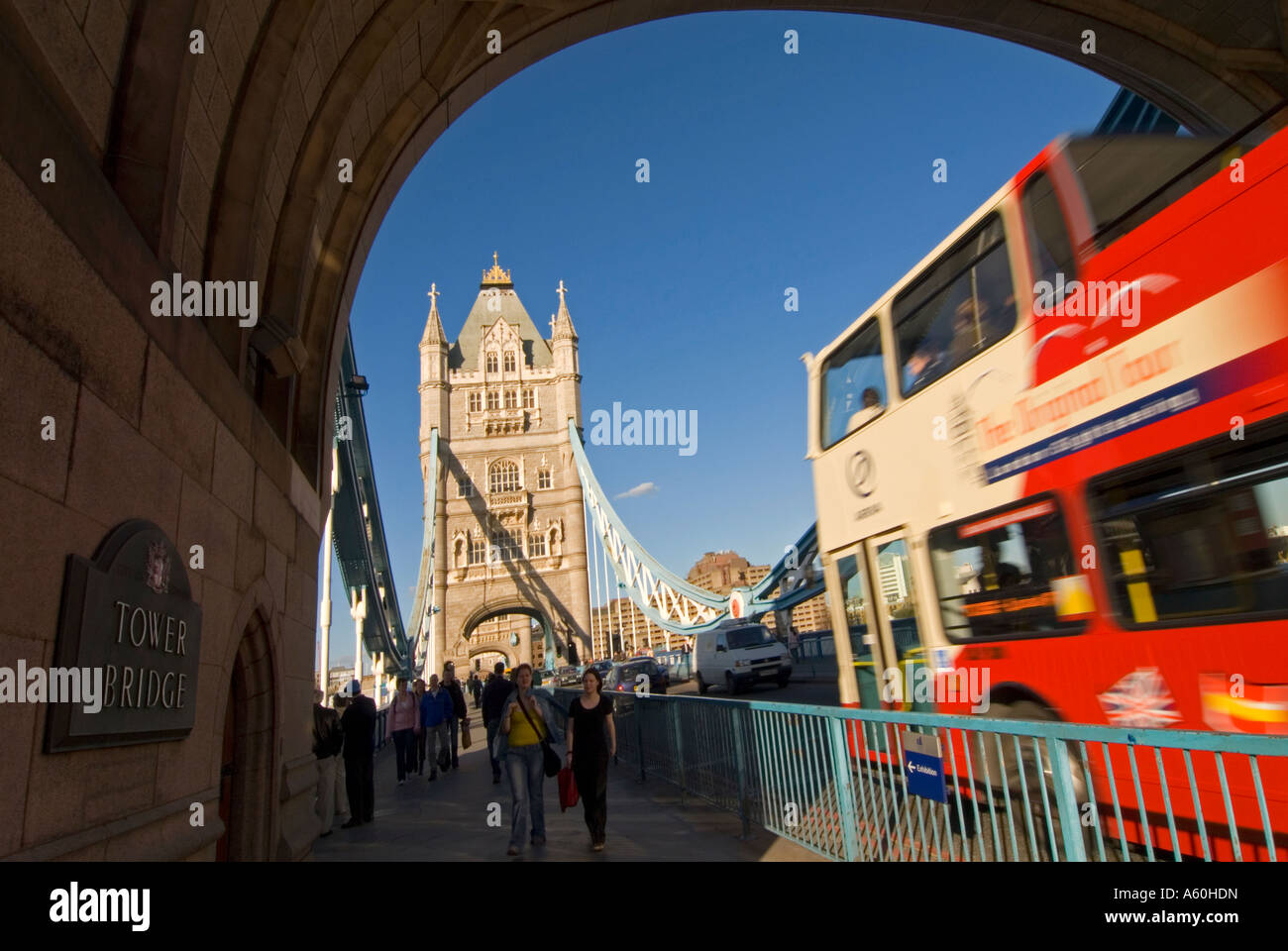 Horizontal wide angle of an open topped tourist bus crossing Tower ...
