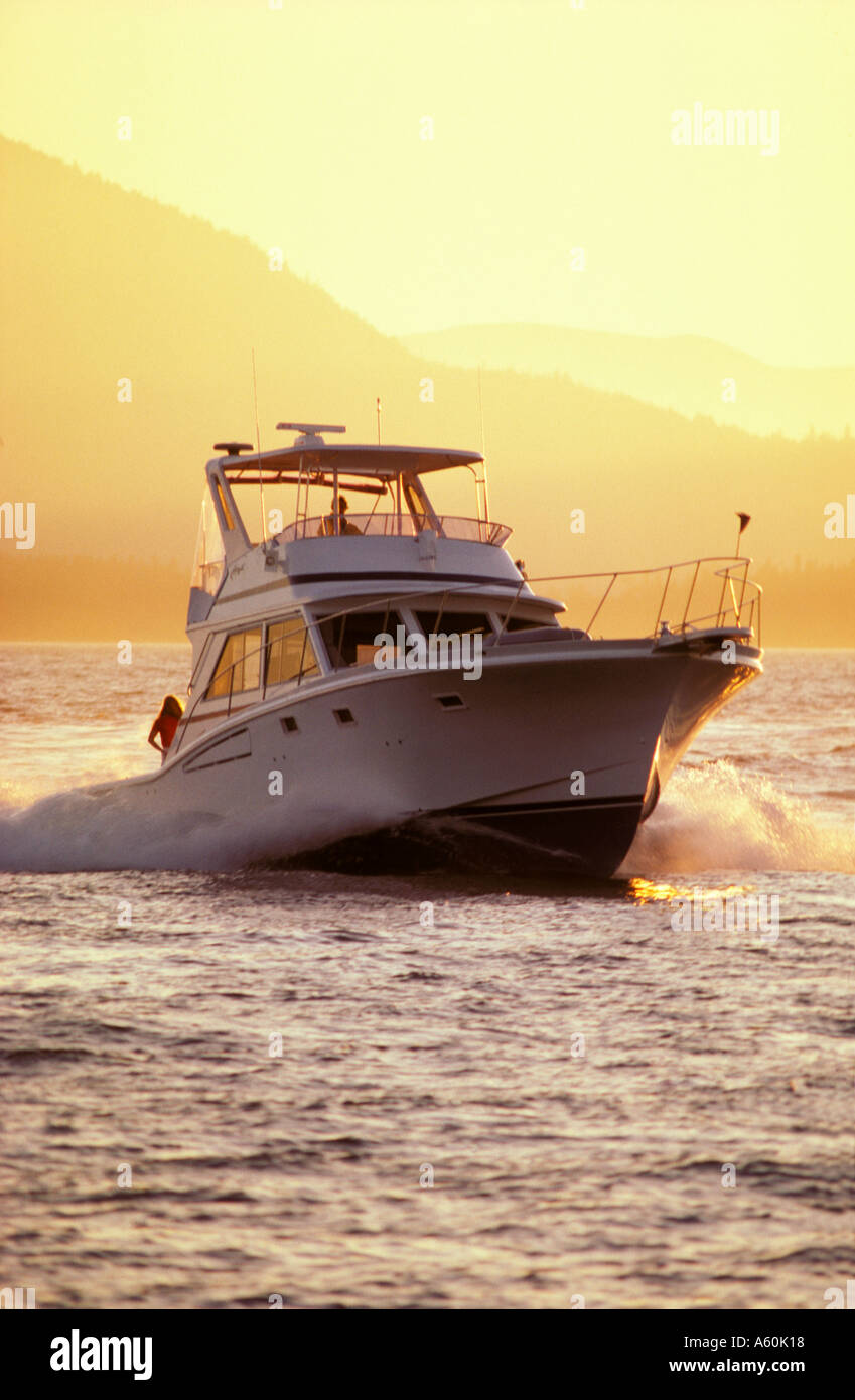 A powerboat speeds across Puget Sound at sunset Stock Photo - Alamy