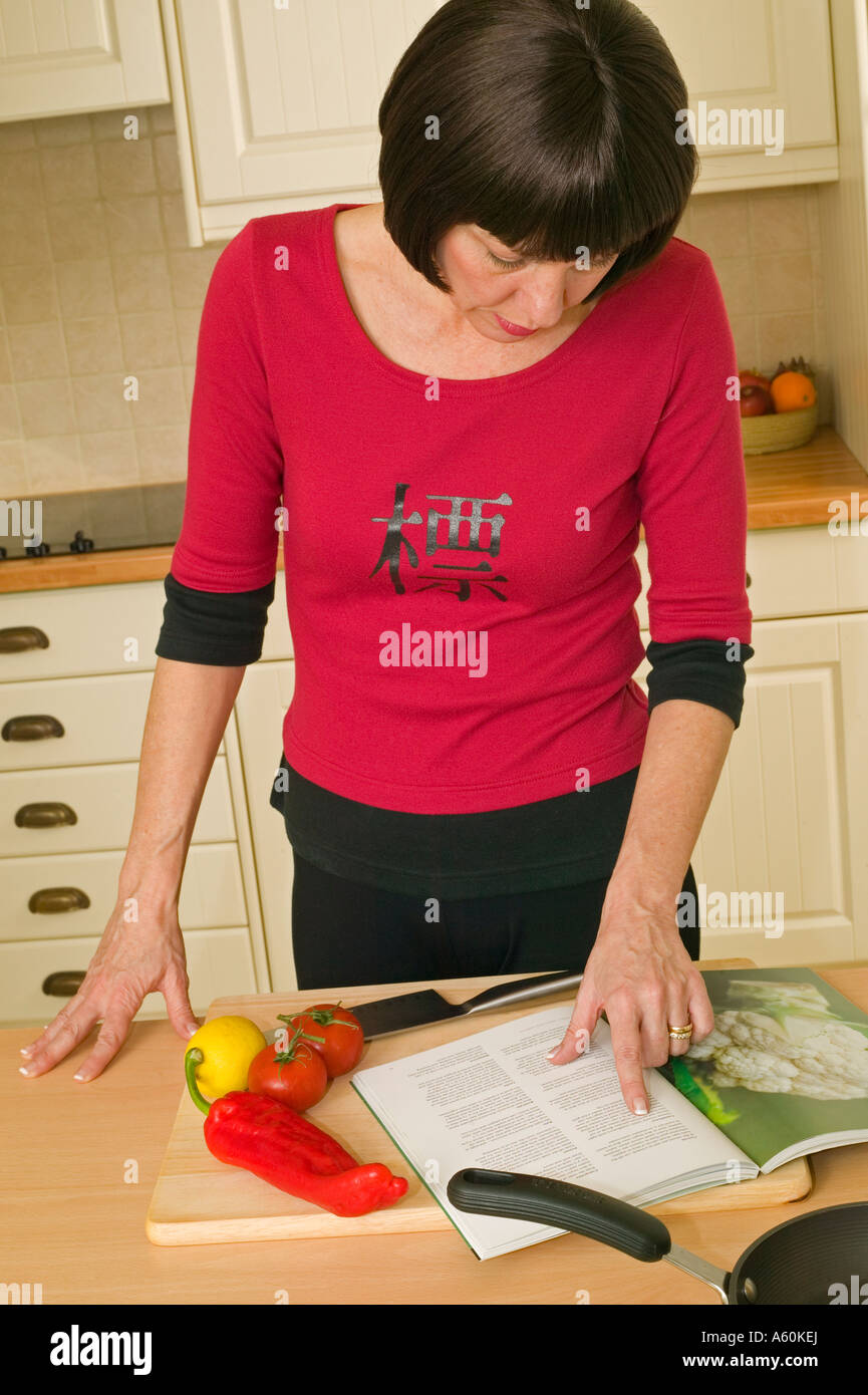 woman reading a recipe book Stock Photo - Alamy