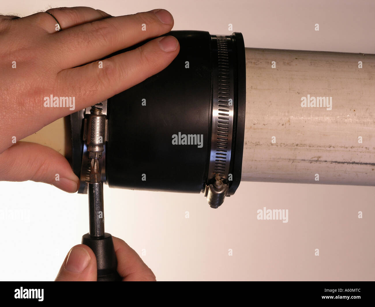 Plumber Installing Boot to Repair Pipe Stock Photo - Alamy