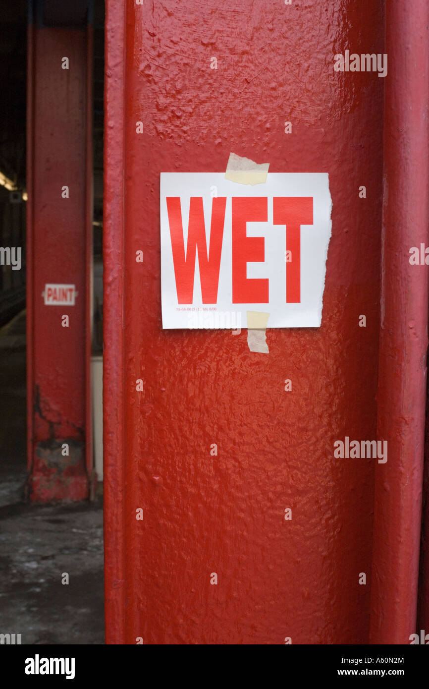 Wet paint signs on subway platform Stock Photo - Alamy
