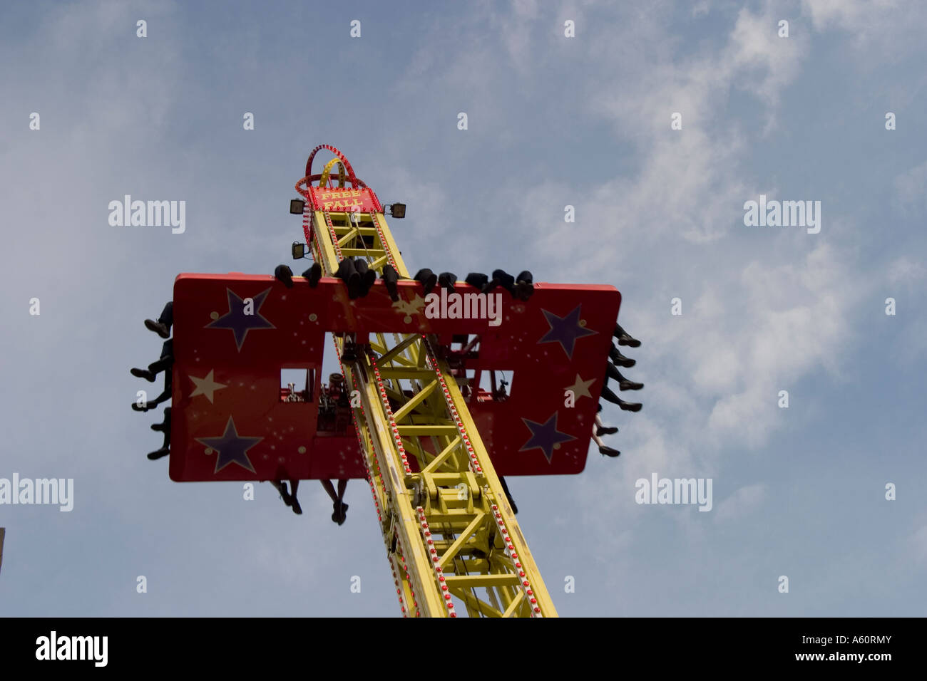 Legs dangling over side of fairground ride Stock Photo - Alamy