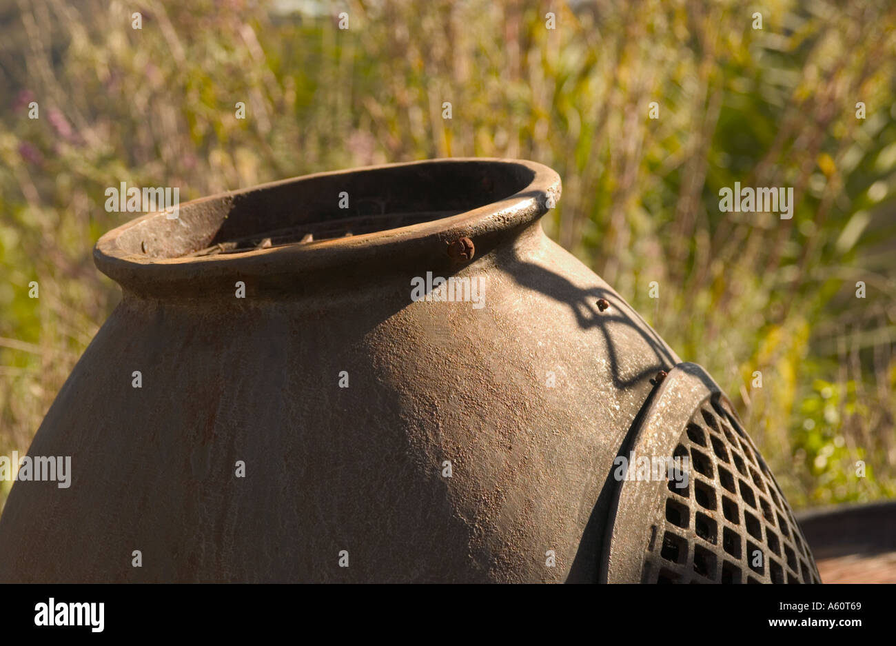 Old, rusty, cast iron potbelly stove in backyard patio Stock Photo - Alamy