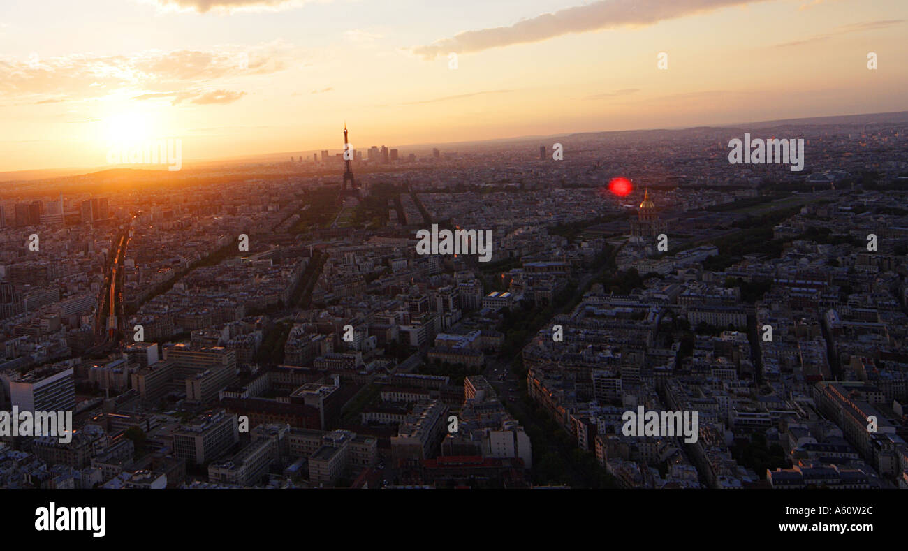Aerial view of Paris at night time with the sun setting on the horizon ...