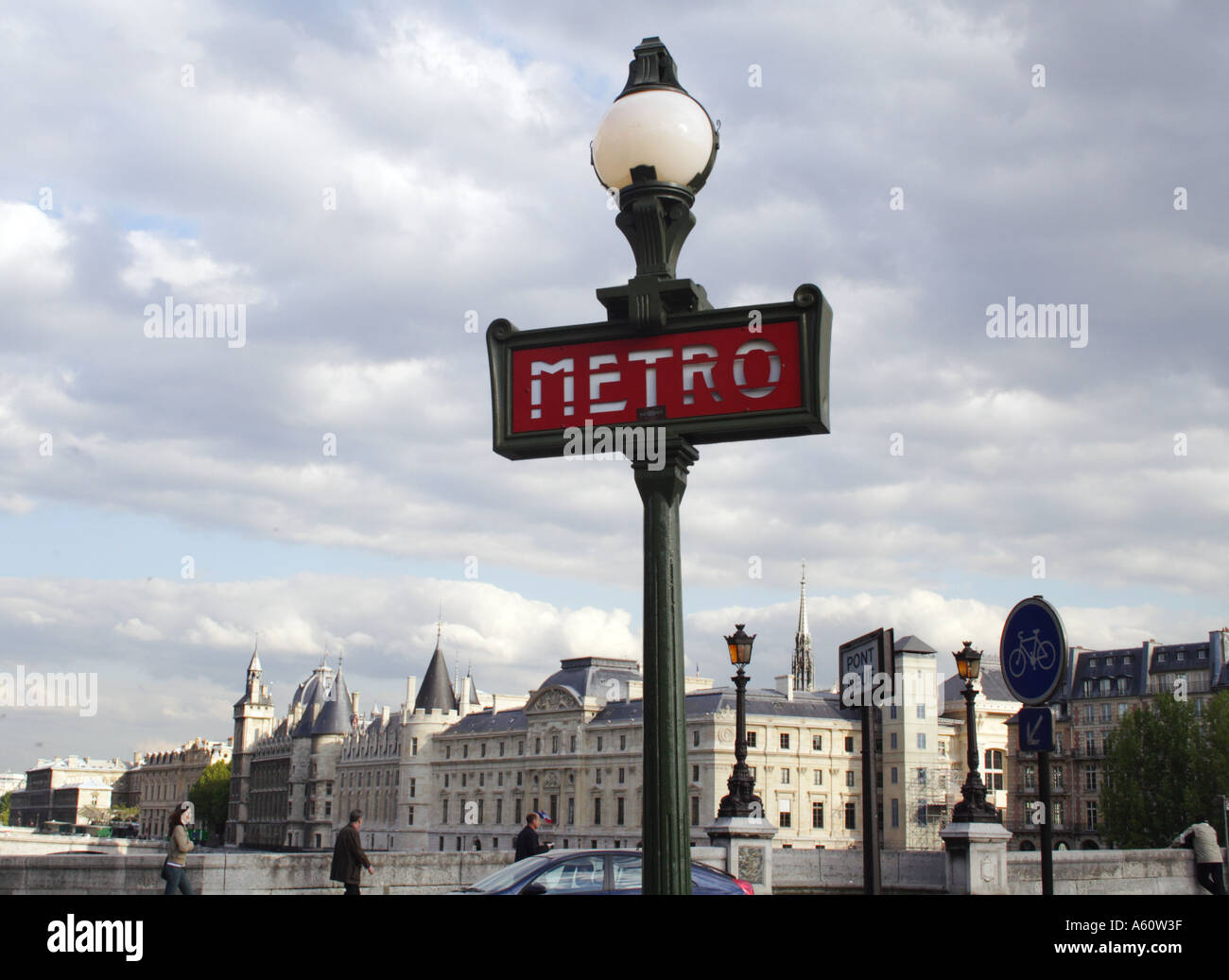 Traditional Metro Sign on the Pont Neuf stop with the Palais de Justice ...