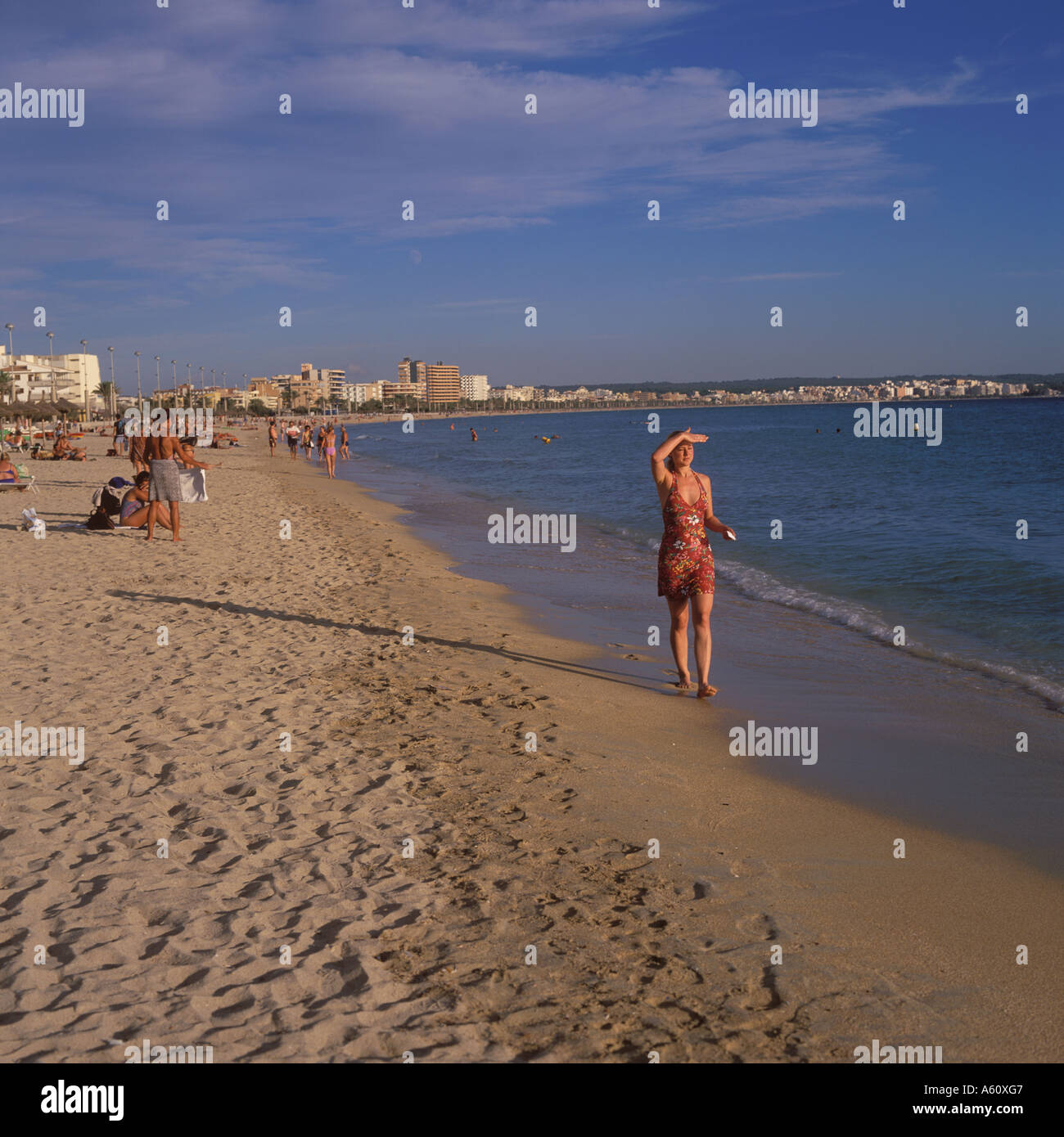 Late afternoon view lady strolling along waters edge looking East along ...