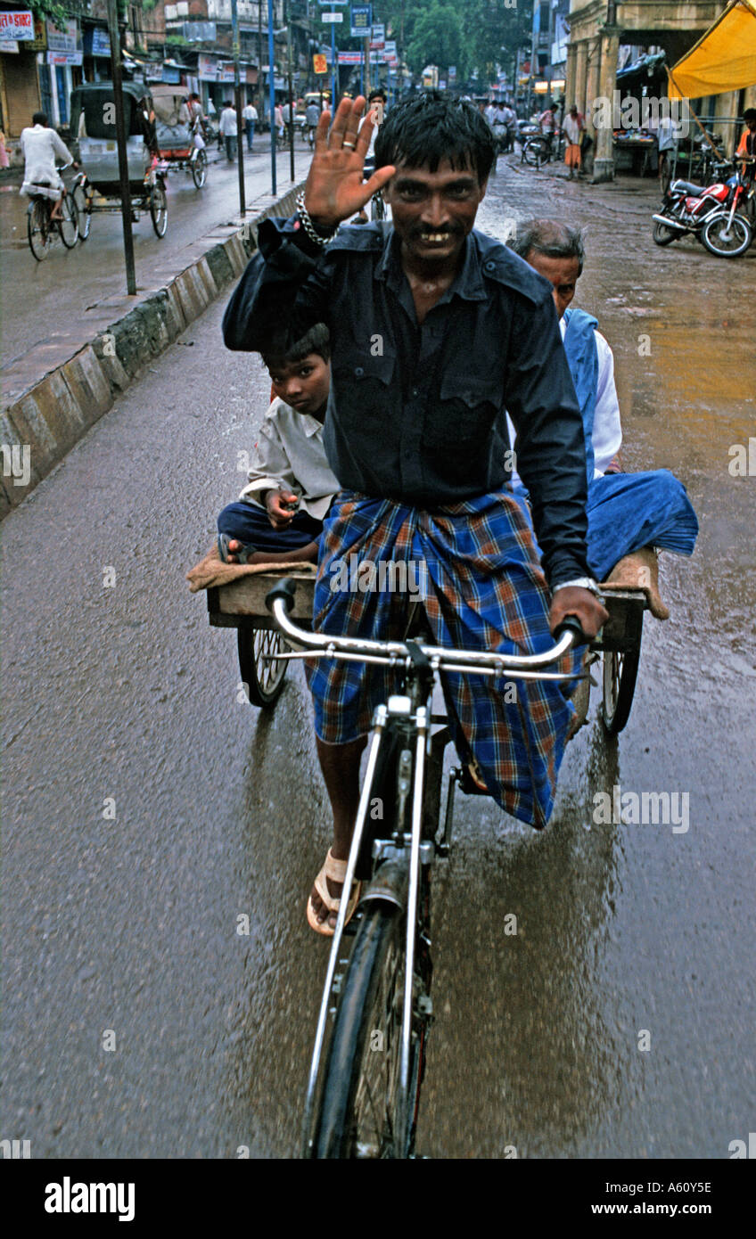 Friendly rickshaw driver holds up his hand as a greeting Varanasi Uttar ...