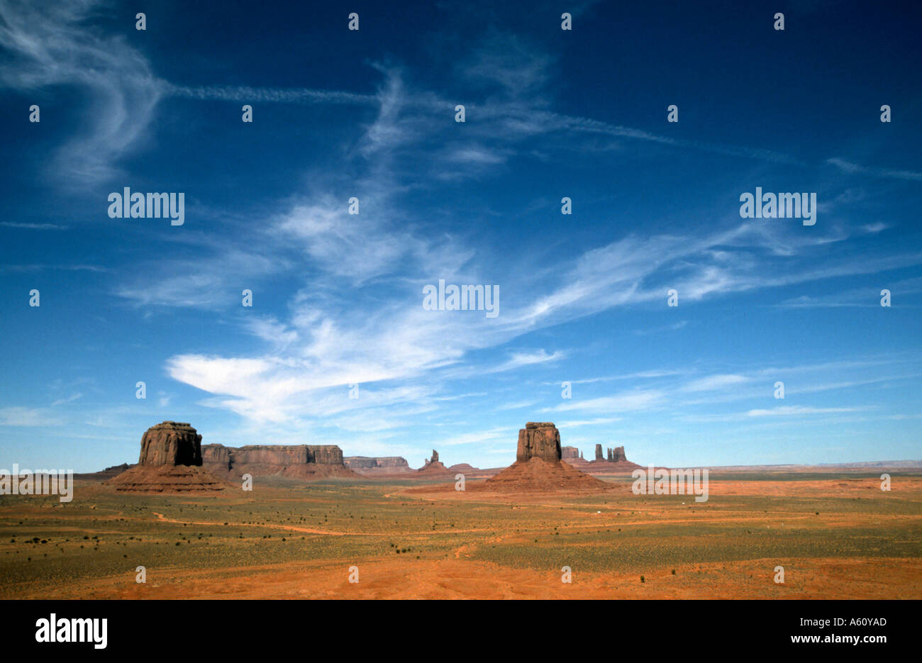 Dark blue summer sky and wispy cloud over the Buttes of Monument Valley ...