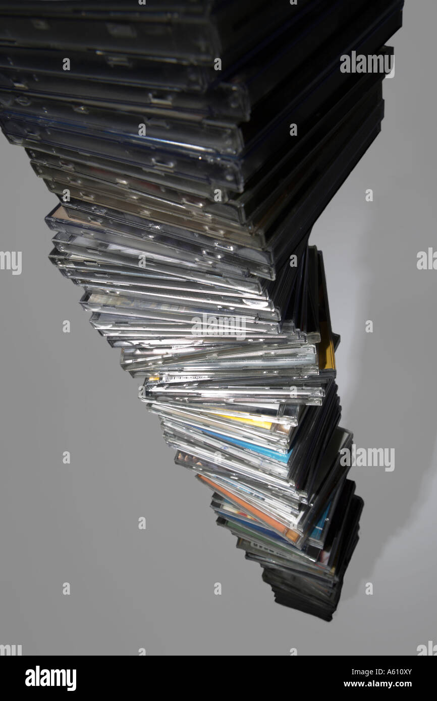 looking down at a very tall stack of cd case on top of each over. two ...