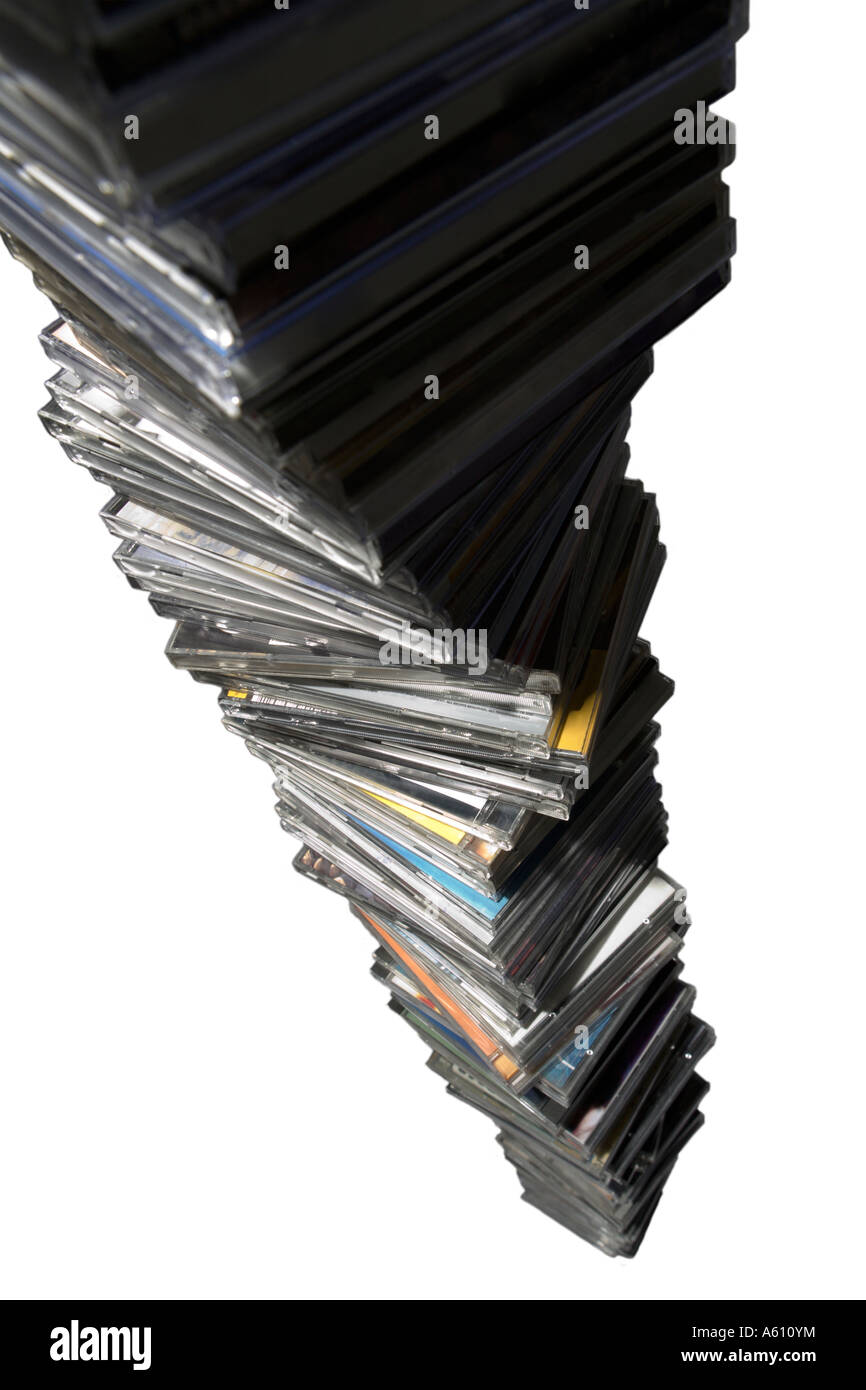 looking down at a very tall stack of cd case on top of each over. three ...