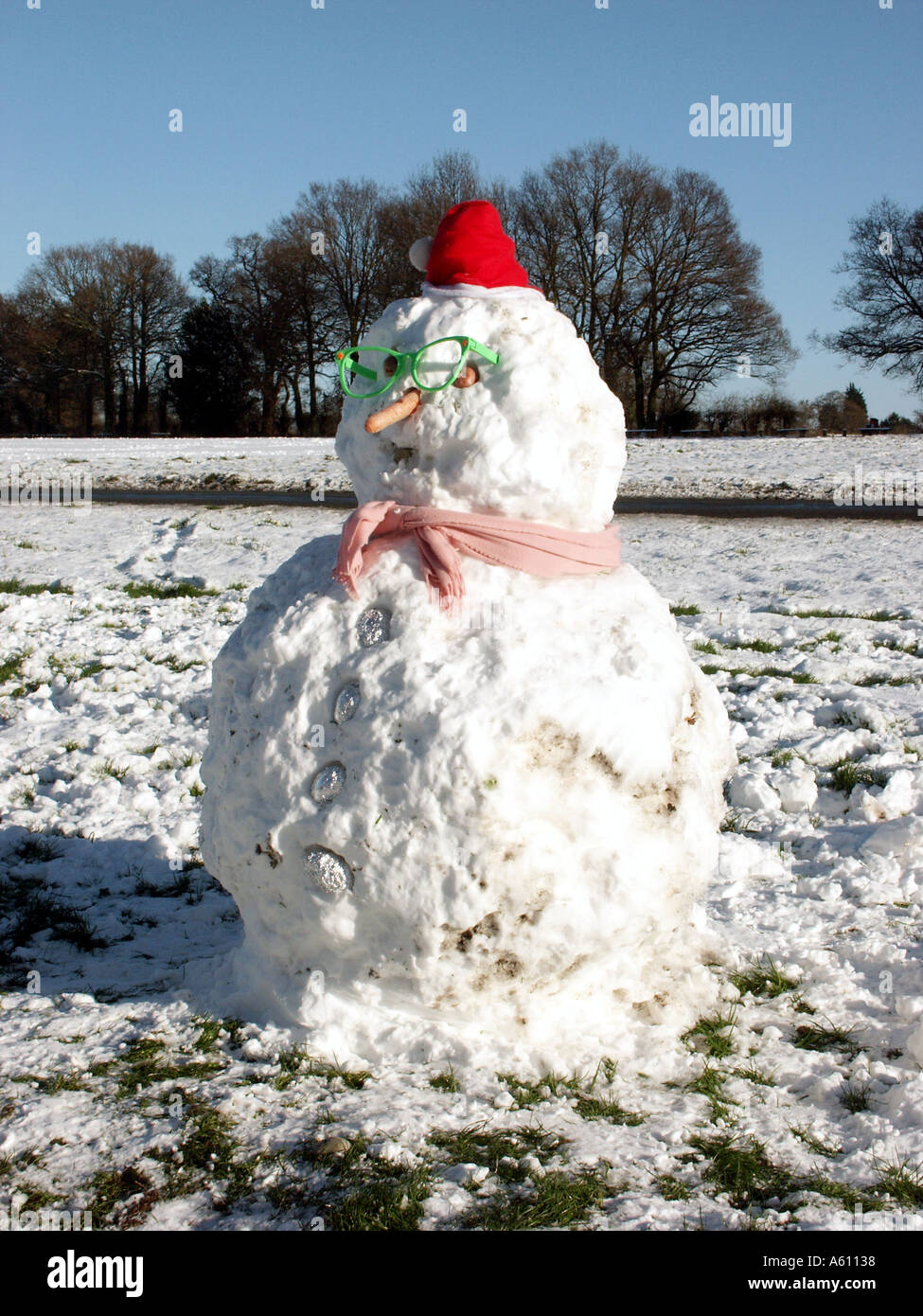 Snowman or snowwoman cold blue sky sunny day winter scene on village ...