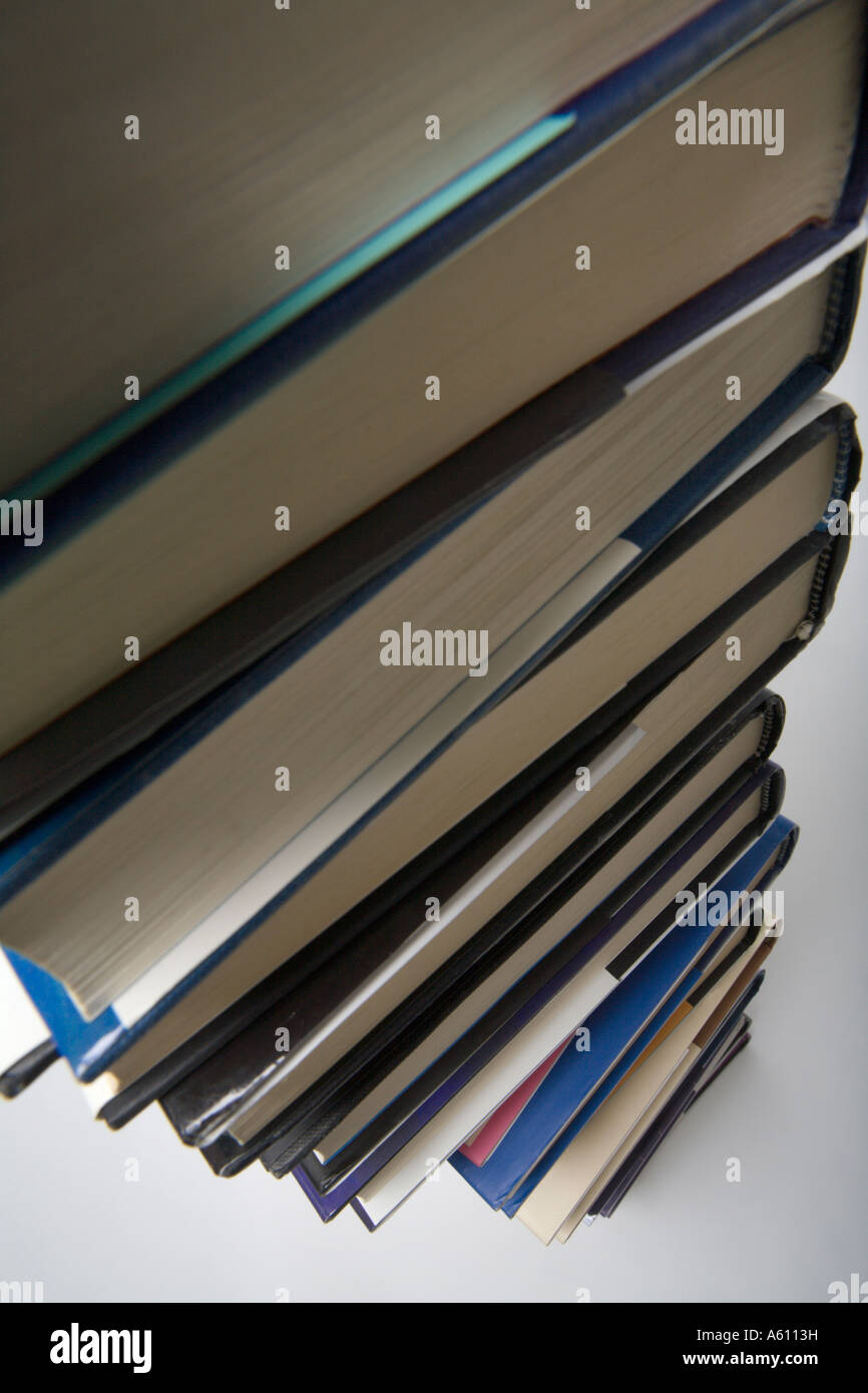 looking down at a tall stack of hardback books Stock Photo - Alamy
