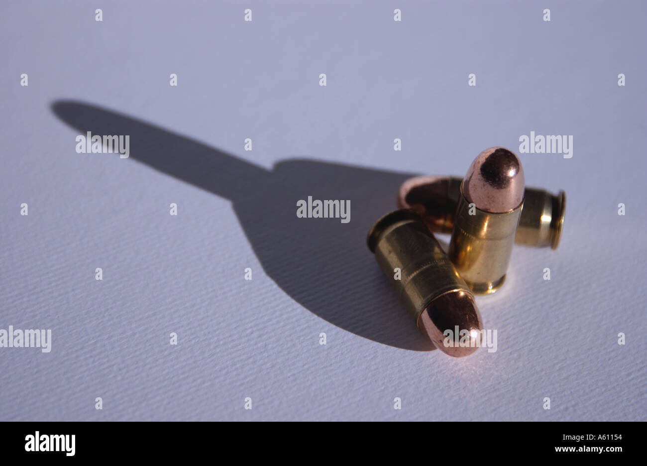 45 acp bullets on white table Stock Photo - Alamy