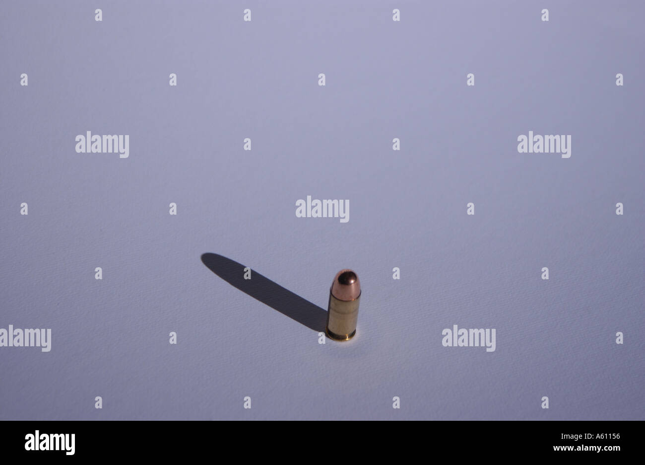 45 acp bullets on white table Stock Photo - Alamy