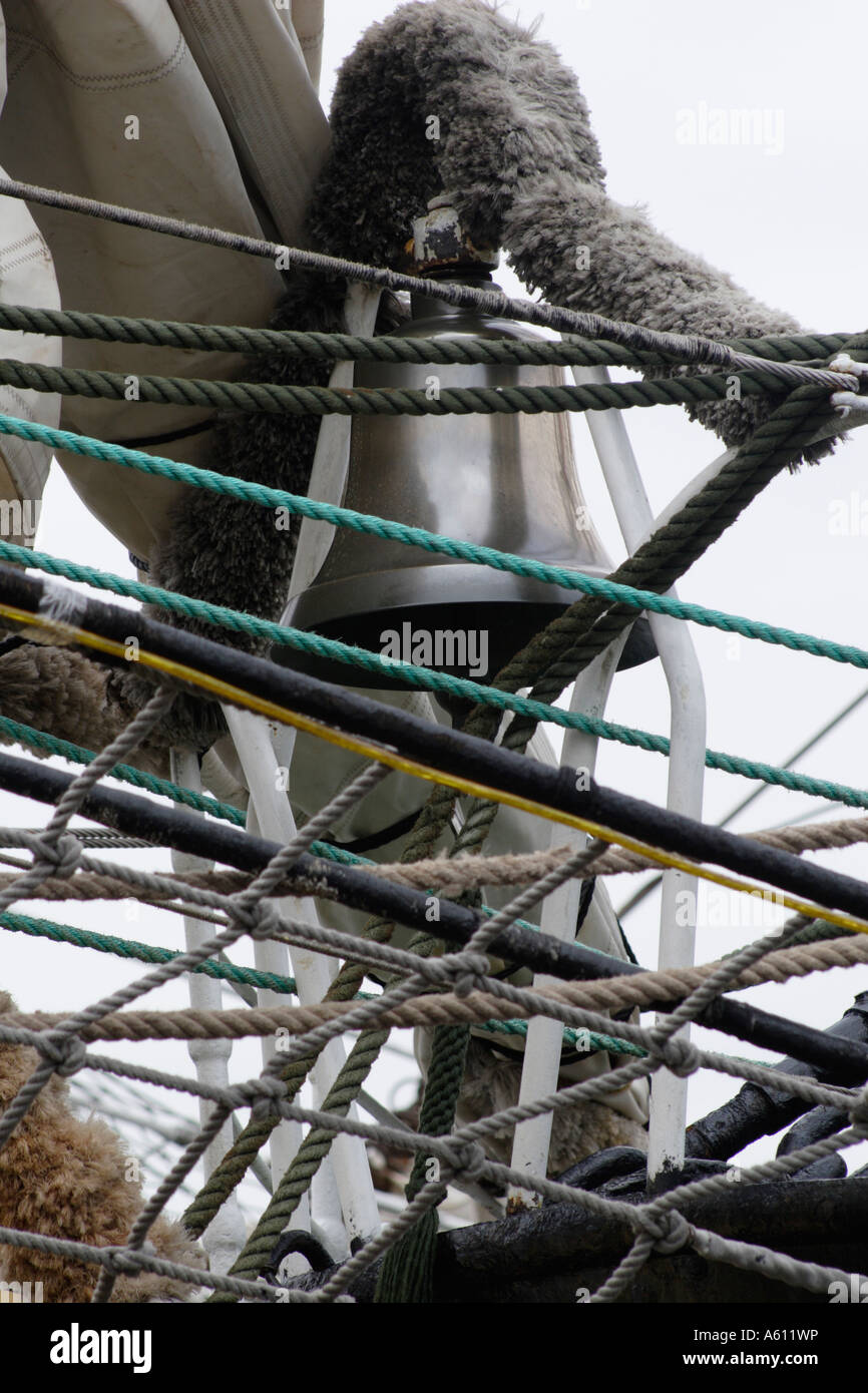 Bell of a tall ship surrounded by rigging ropes Stock Photo - Alamy
