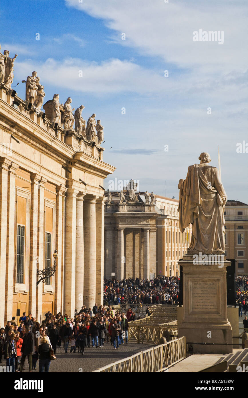 Statues on the roof of St Peters basilica overlooking the crowds ...