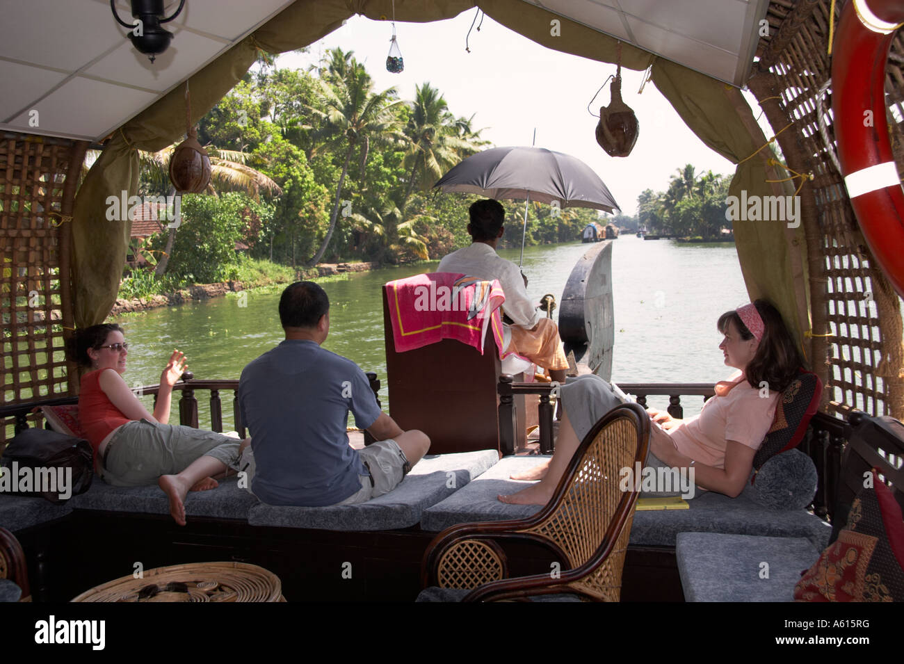 Tourists on a houseboat cruising the Kuttanad the backwaters of Kerala ...