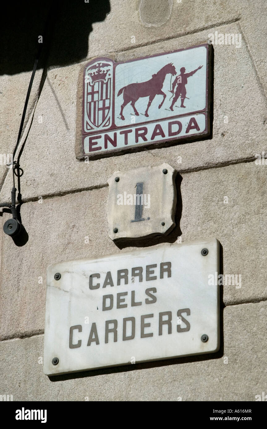 Old entrada (entrance) sign with horse and man image on wall in Carrer ...