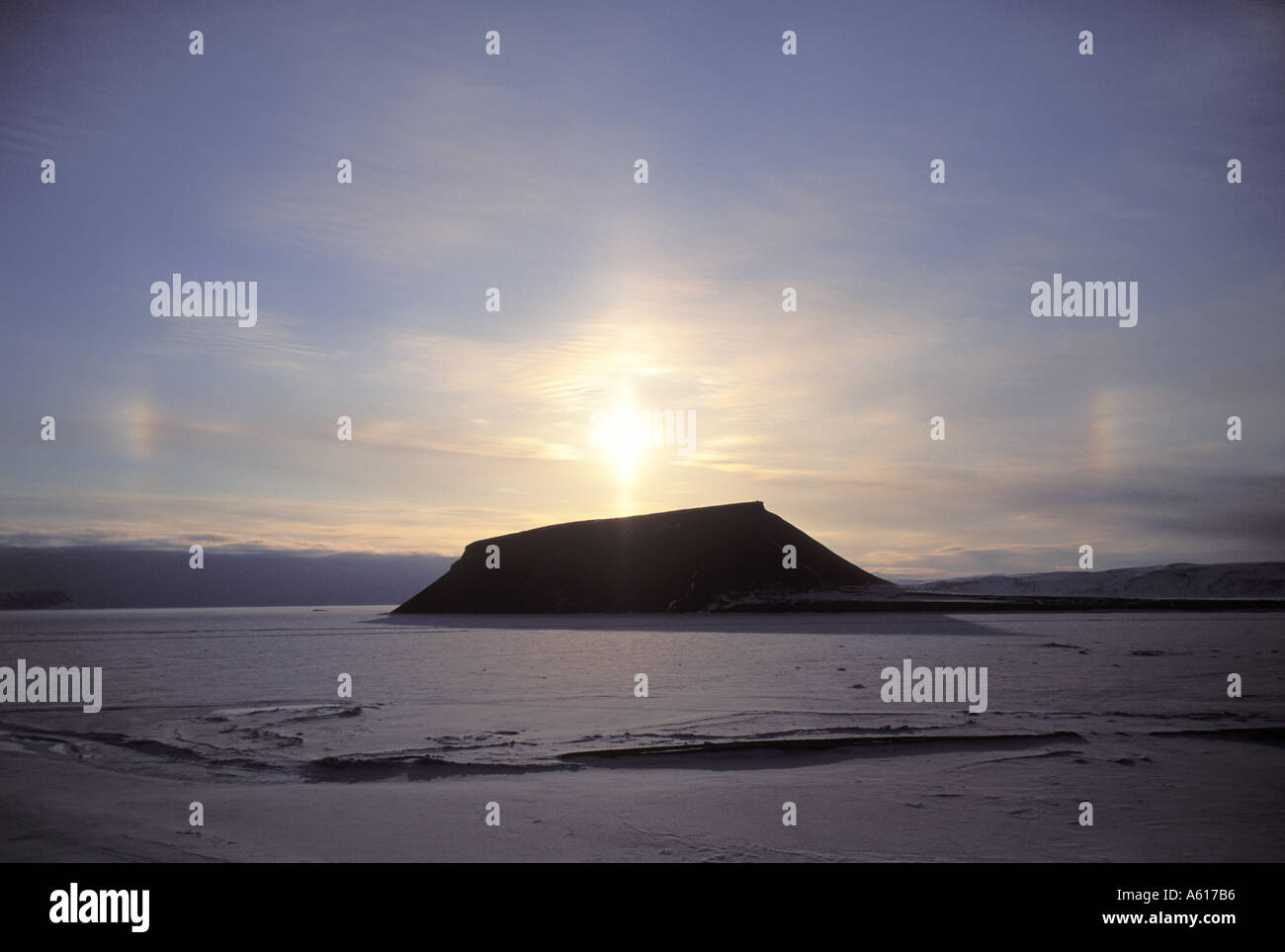 Sunset with light pillar and sundogs Thule Greenland Stock Photo - Alamy