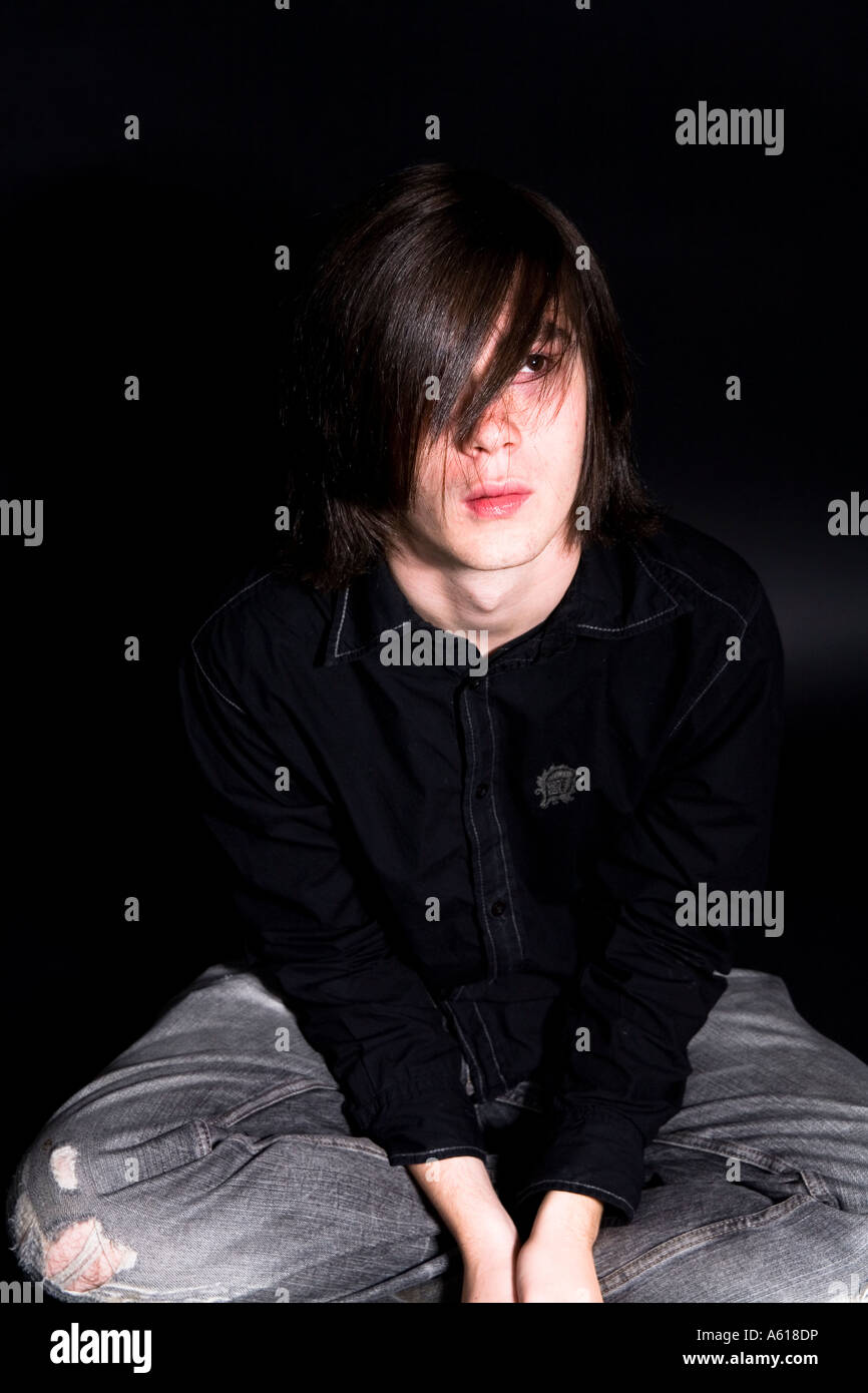 Young boy aged 16 sat down in lonely pose and glance Stock Photo - Alamy