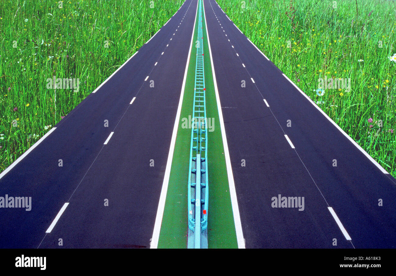 Highway running through meadow field Stock Photo - Alamy
