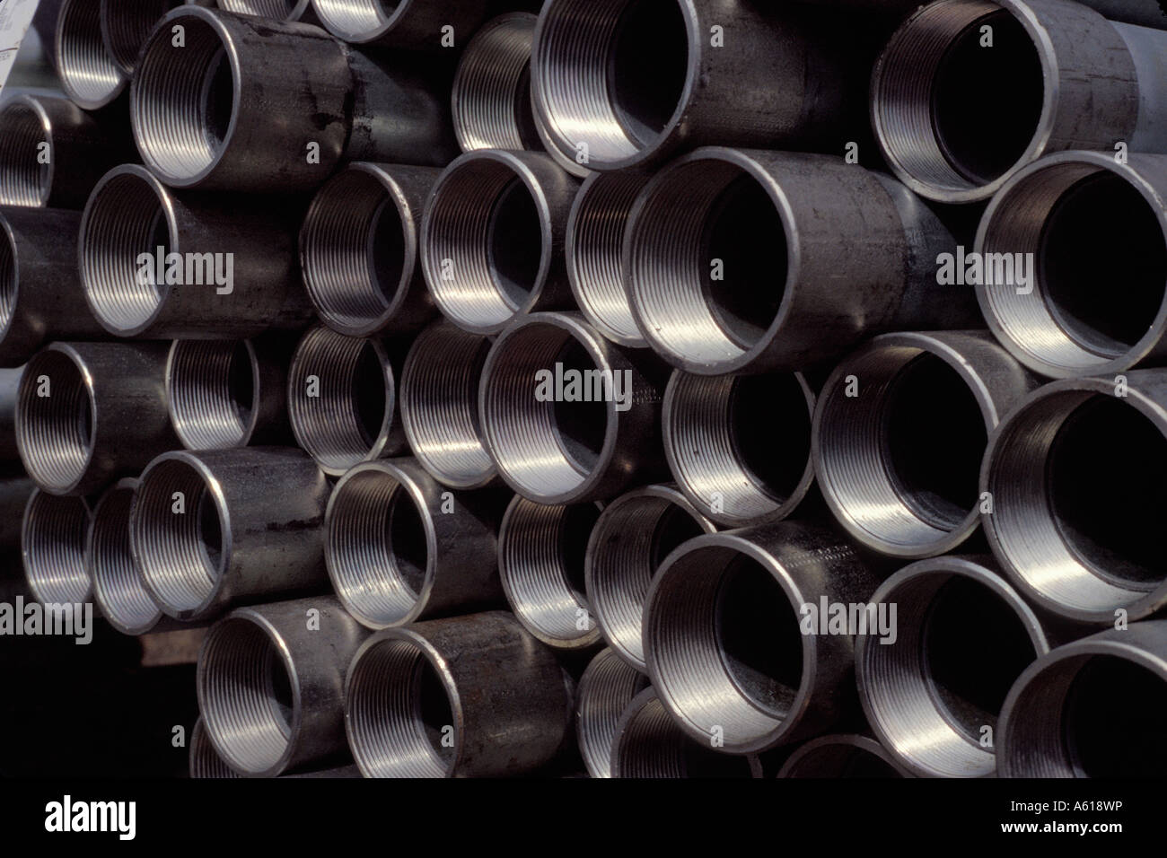 Stack of threaded metal pipe Stock Photo - Alamy