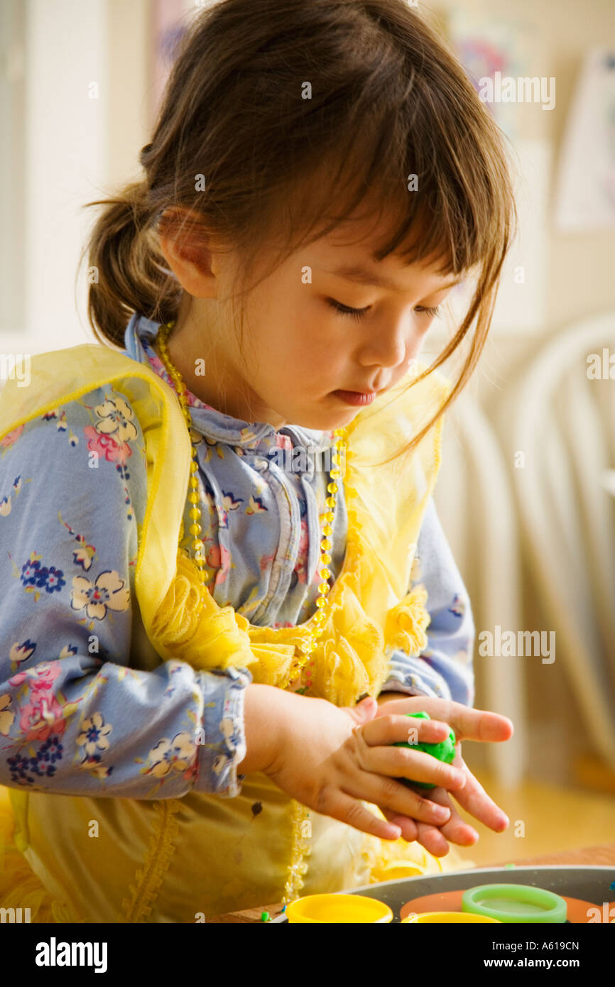 Asian girl playing with clay Stock Photo - Alamy