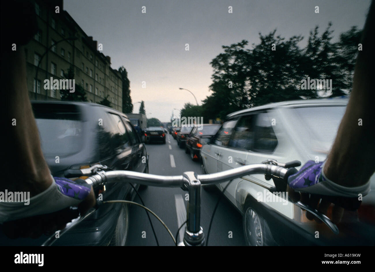 Cyclist between cars Stock Photo - Alamy