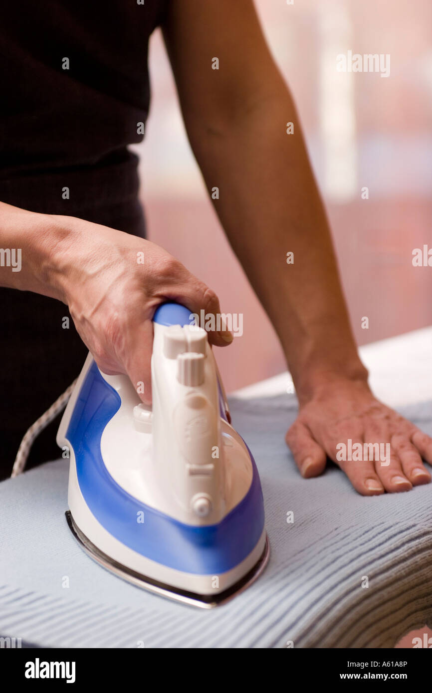 Hands with flat-iron Stock Photo - Alamy