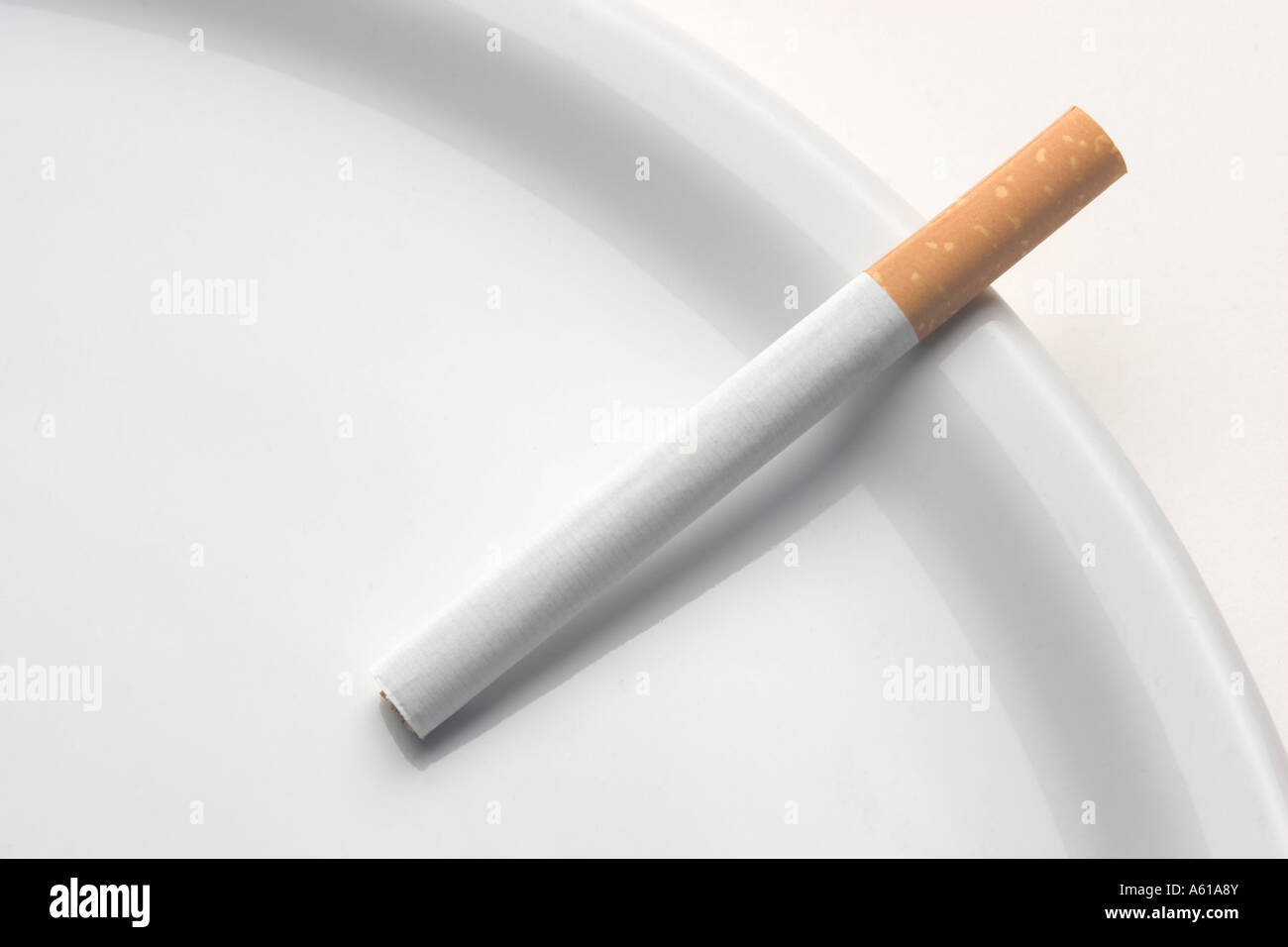 Cigarette on plate Stock Photo - Alamy