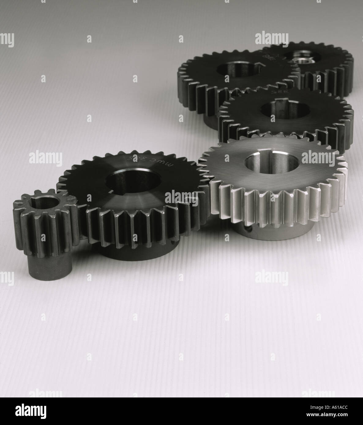 Synchronized gears connected Stock Photo - Alamy